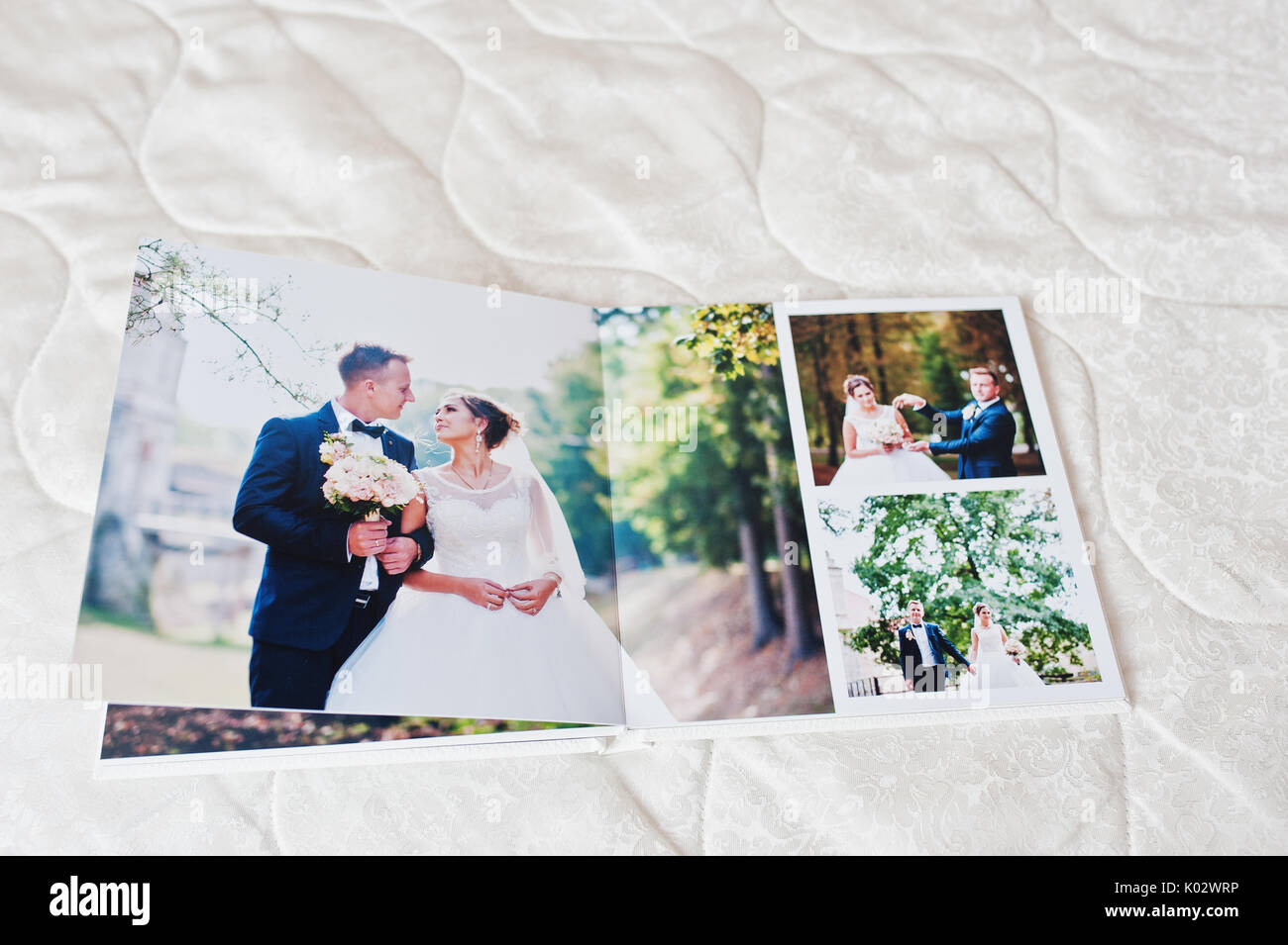 Pages of wedding photobook or wedding album on white sofa background ...