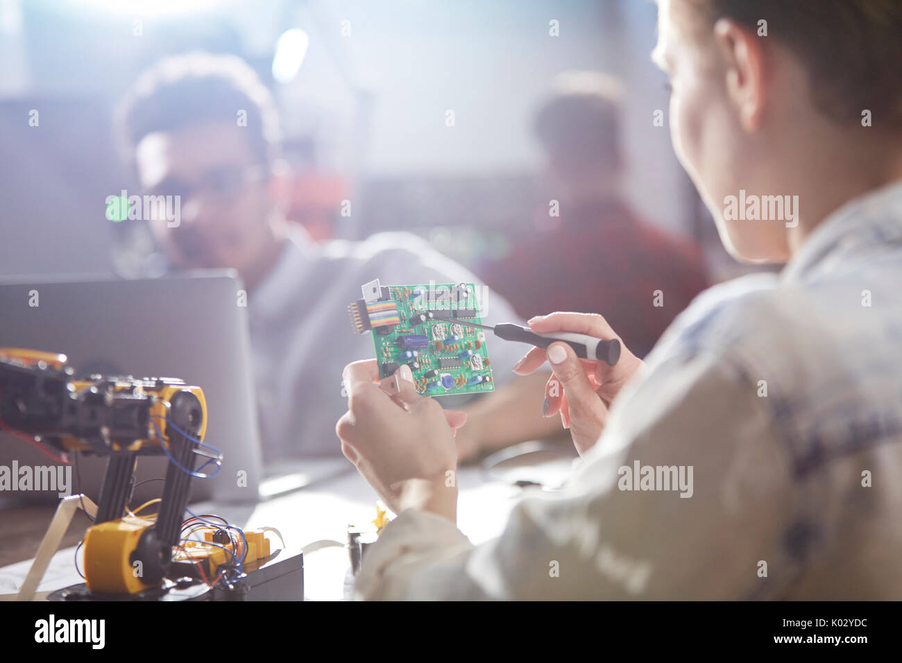 Female engineer assembling circuit board with soldering iron Stock ...