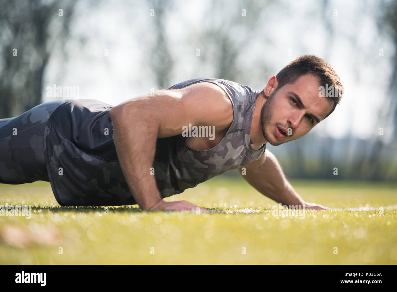 Young Man Doing Pushups in City Park Area - Training and Exercising for ...