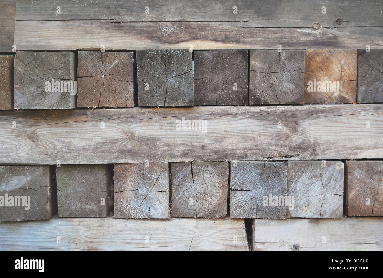 Texture wooden square logs stacked in rows Stock Photo - Alamy