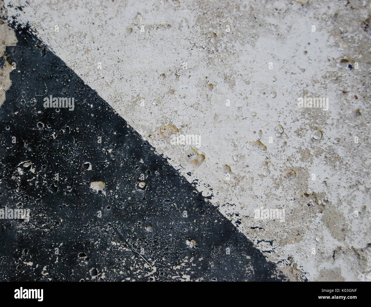 The texture of the concrete column, painted in two colors: black and ...