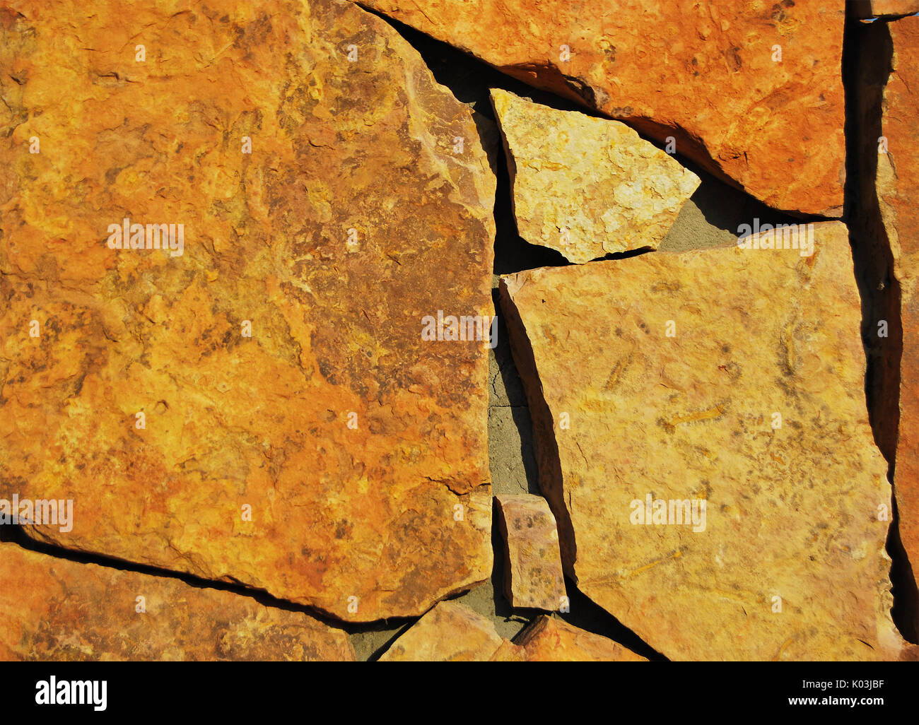 Texture of a laying of a yellow stone closeup Stock Photo - Alamy