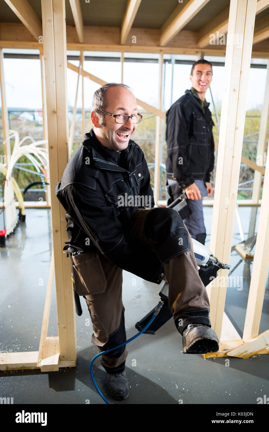 Funny Carpenter With Drill Machine Standing At Site Stock Photo - Alamy