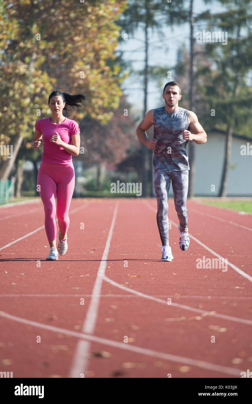 Attractive Couple Sprinting on the Running Track in City Park Area ...