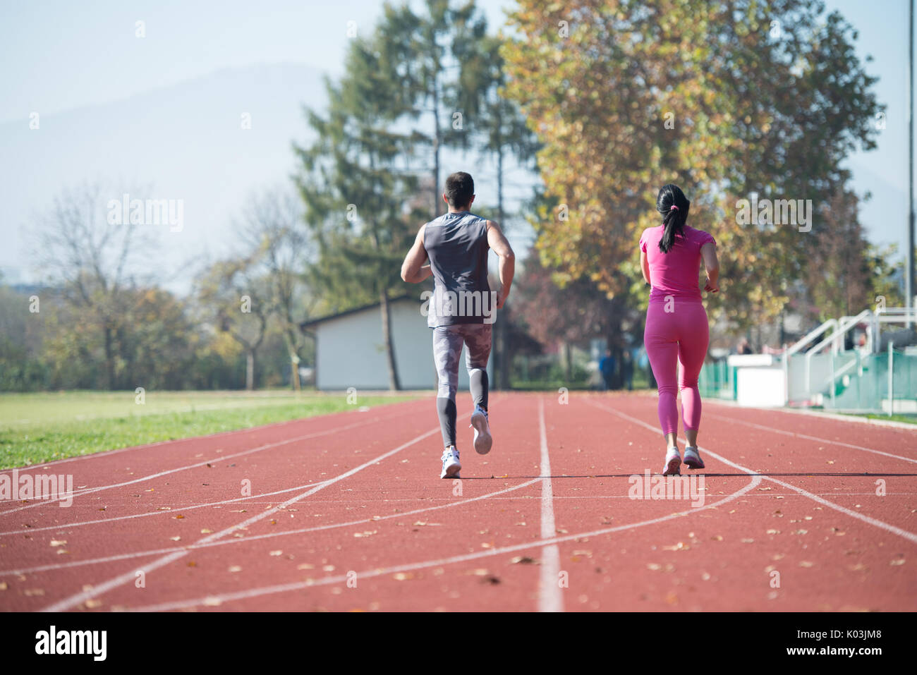 Attractive Couple Sprinting on the Running Track in City Park Area ...