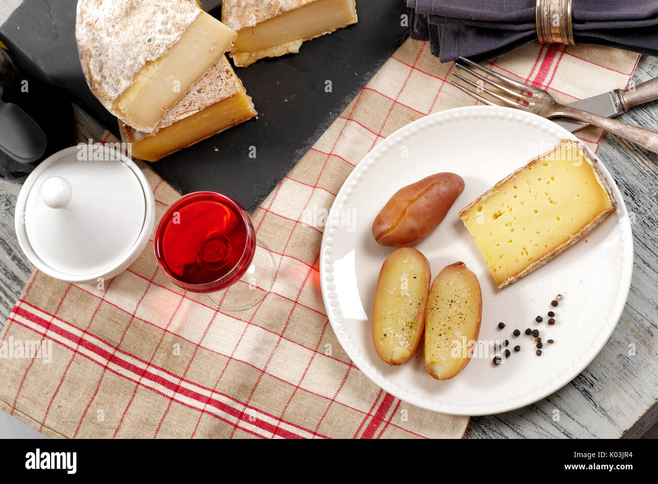 Different french cheeses with a glass of red wine Stock Photo - Alamy