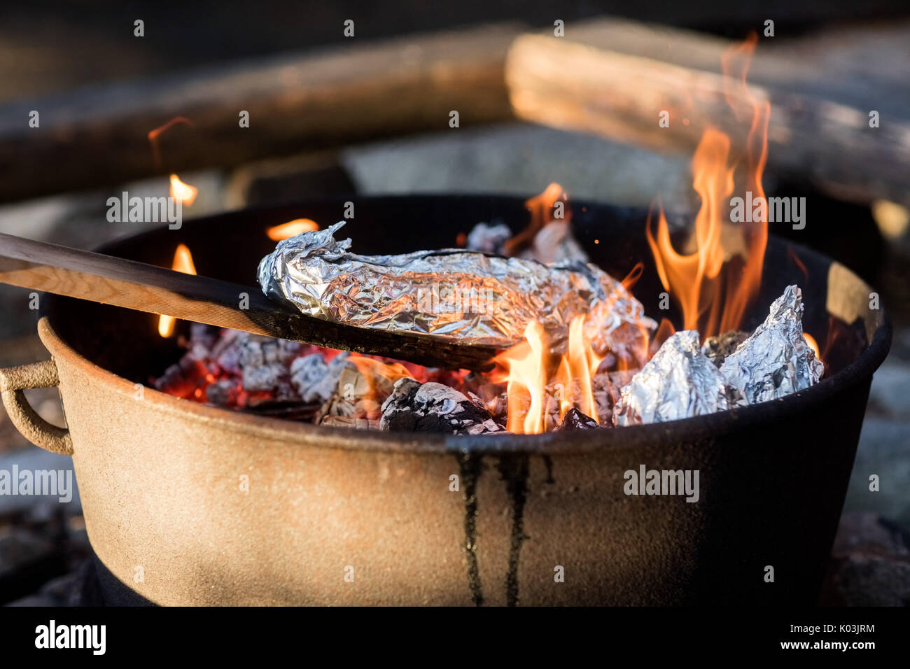 Food Wrapped In Foil Being Cooked On Firepit Stock Photo - Alamy