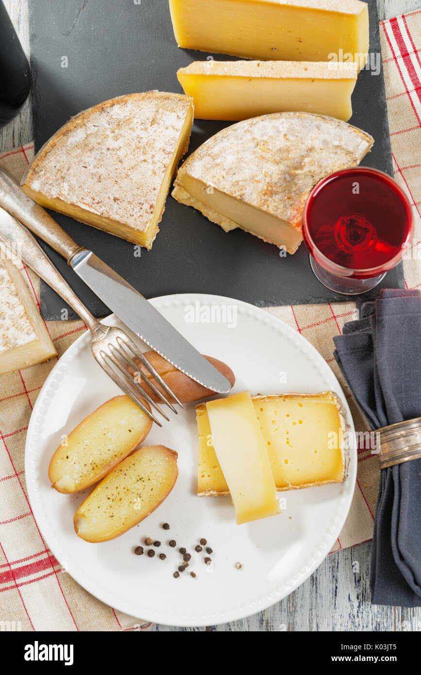 Different french cheeses with a glass of red wine Stock Photo - Alamy