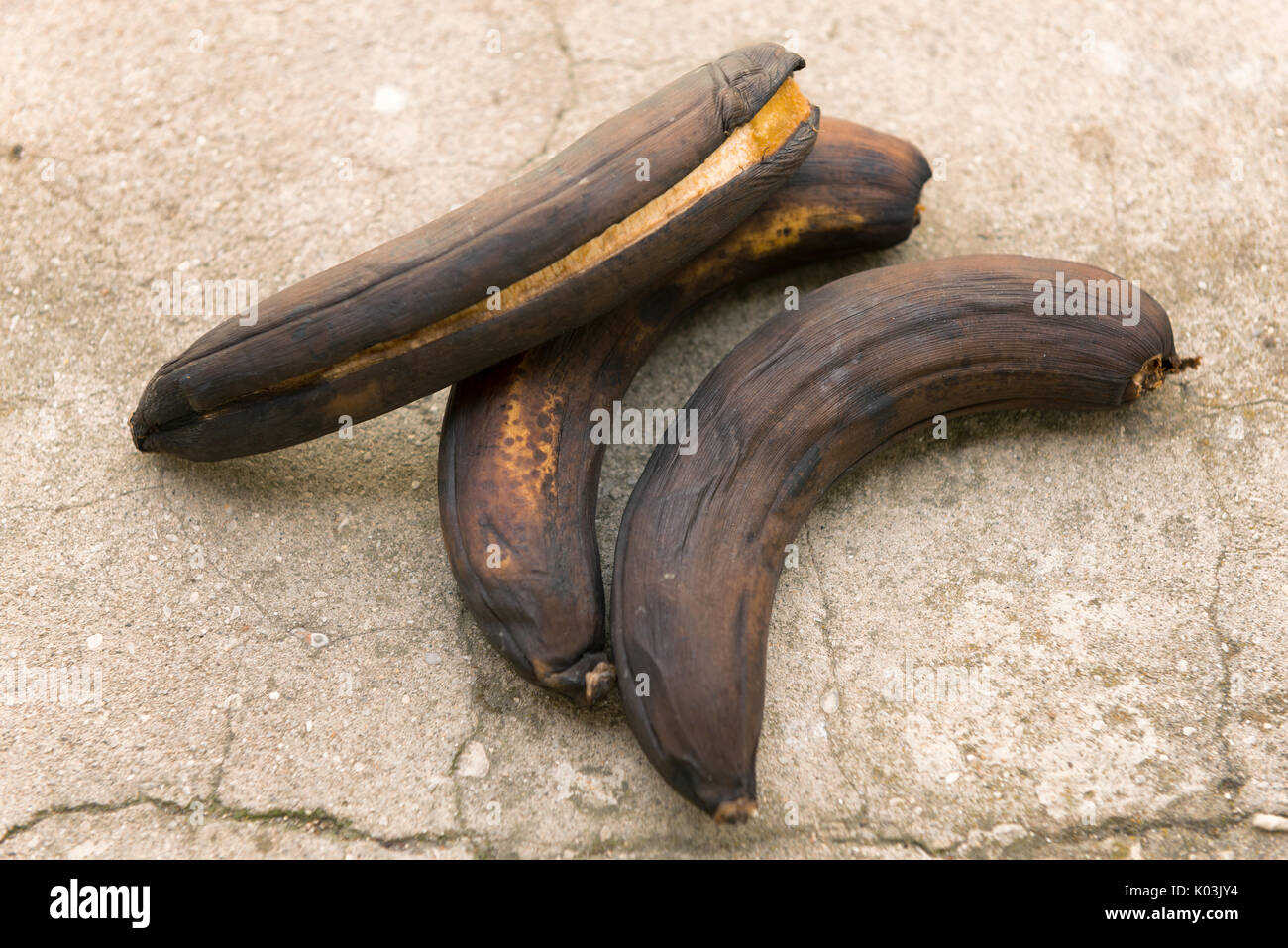 three black rotten banana on the ground Stock Photo - Alamy