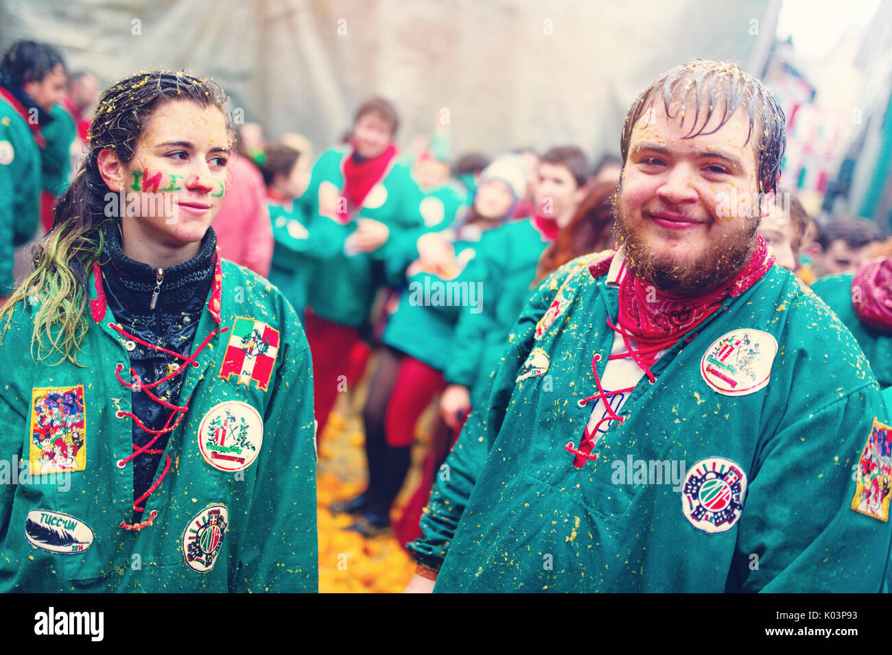 People with traditional costumes during the battle of the oranges ...