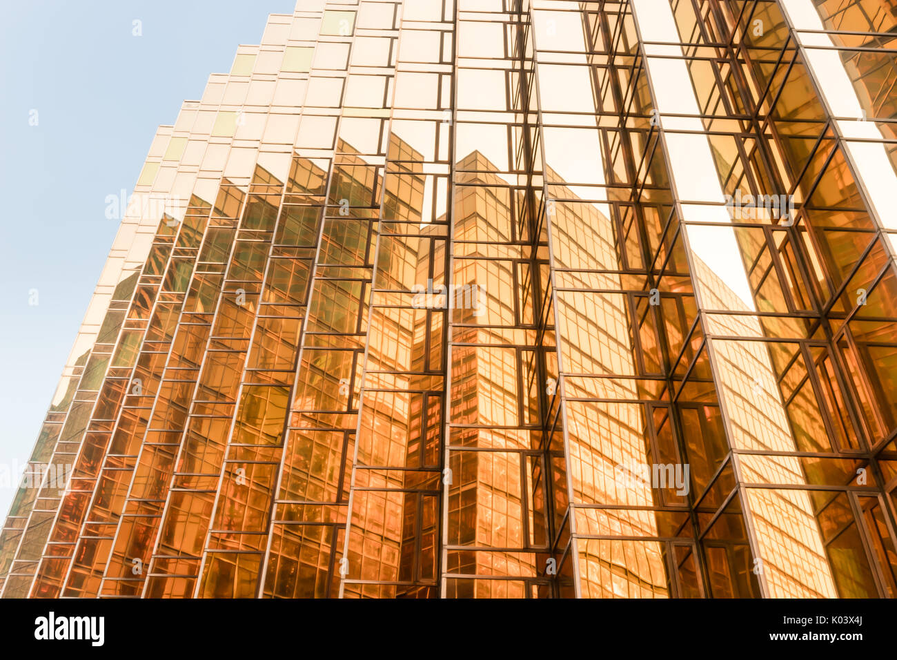 Gold colour office building tower facade in business center Stock Photo ...