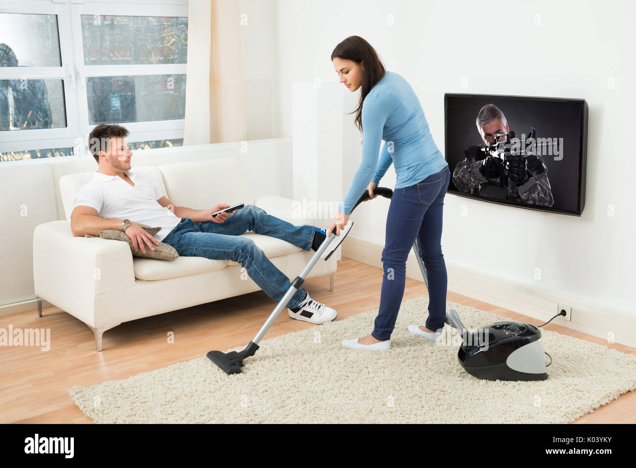 Young man watching tv woman hi-res stock photography and images - Alamy
