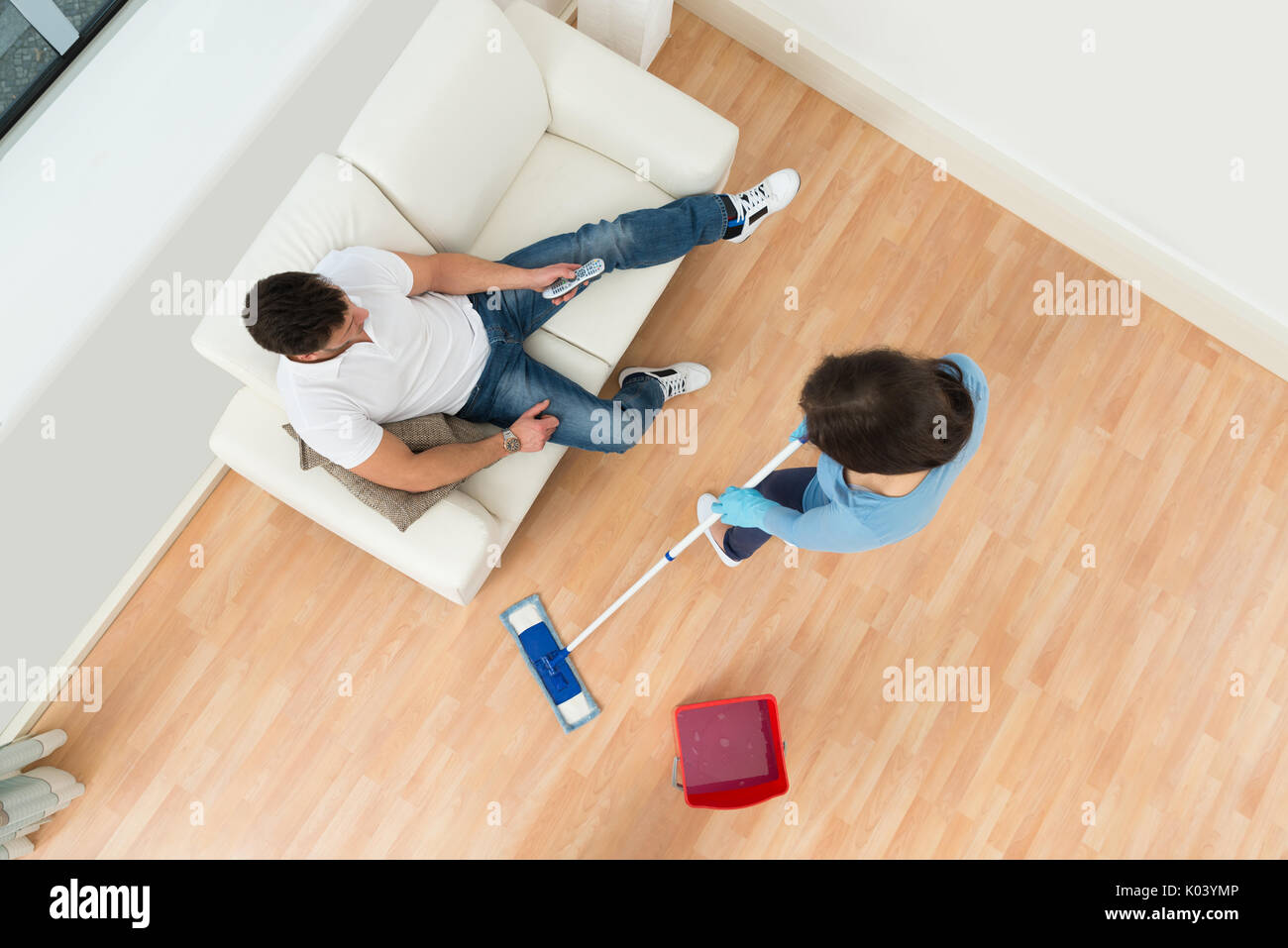Woman cleaning man watching tv hi-res stock photography and images - Alamy