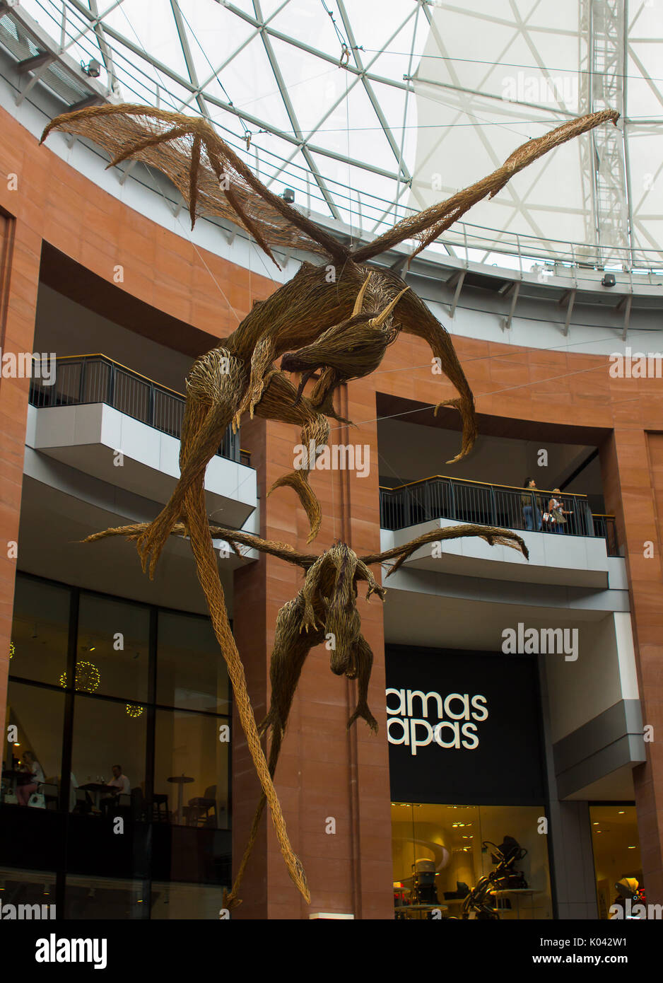 Wicker work winged dragons suspended in the central stairwell of the ...