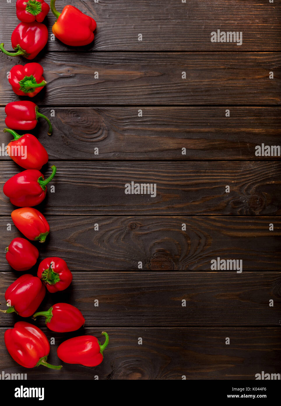 Sweet bulgarian red peppers on a dark wooden background. Selective ...