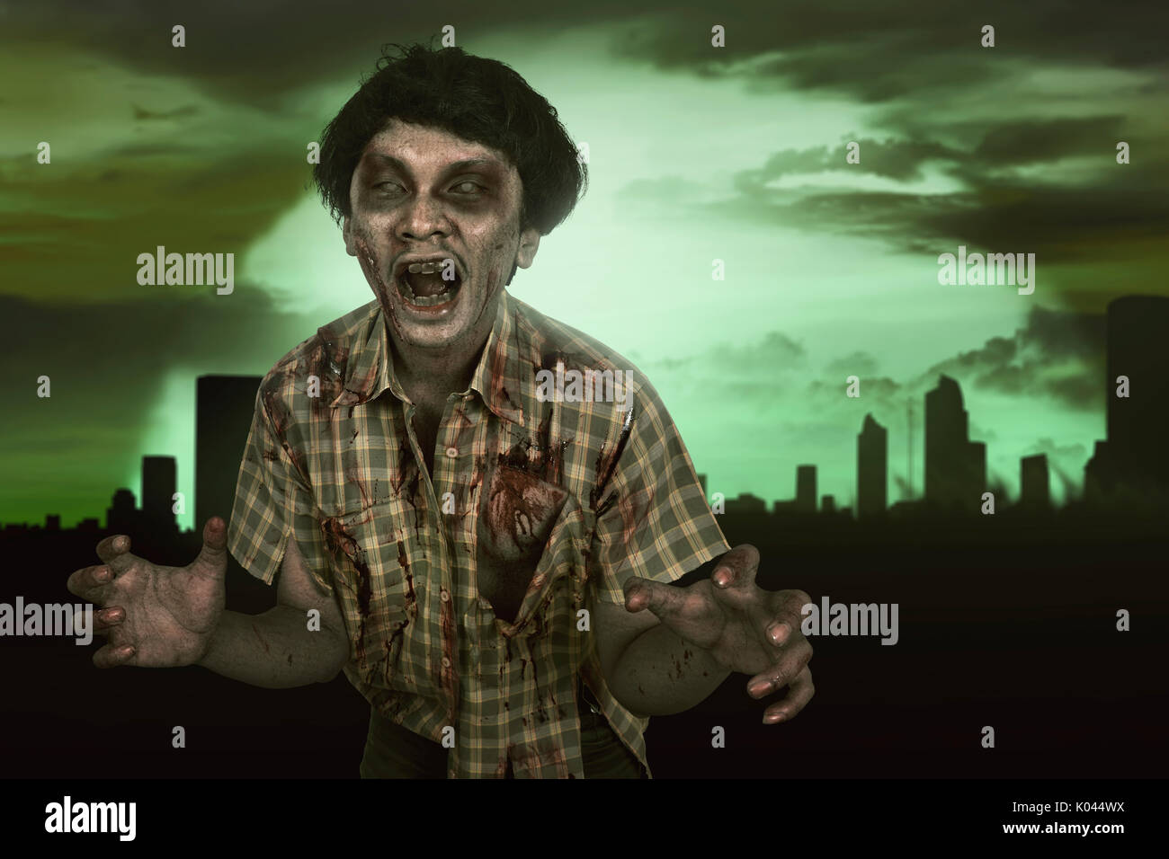 Horrible asian zombie man with wound in the body standing on the dark ...