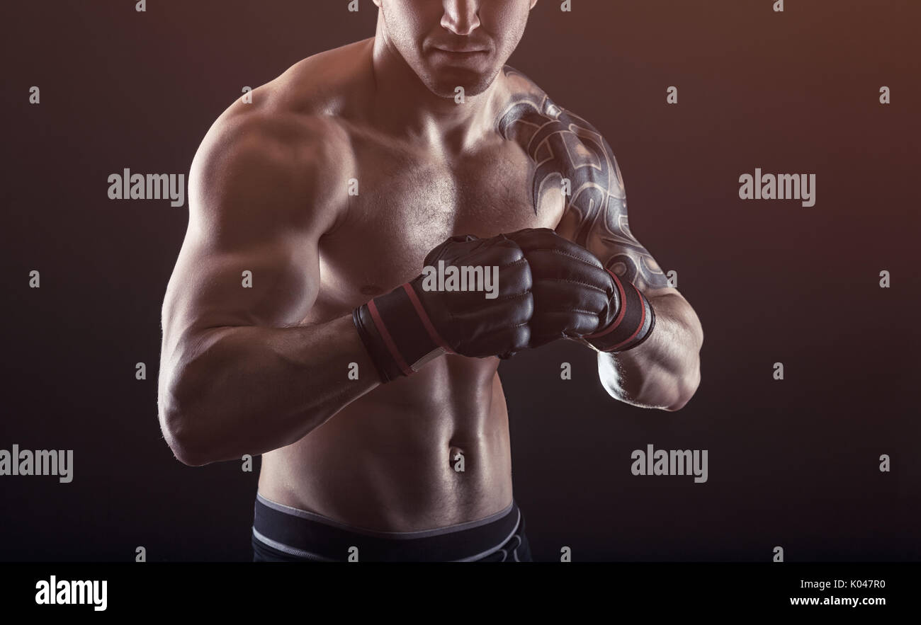 Boxer with boxing gloves before a fight on a black background. Boxing ...