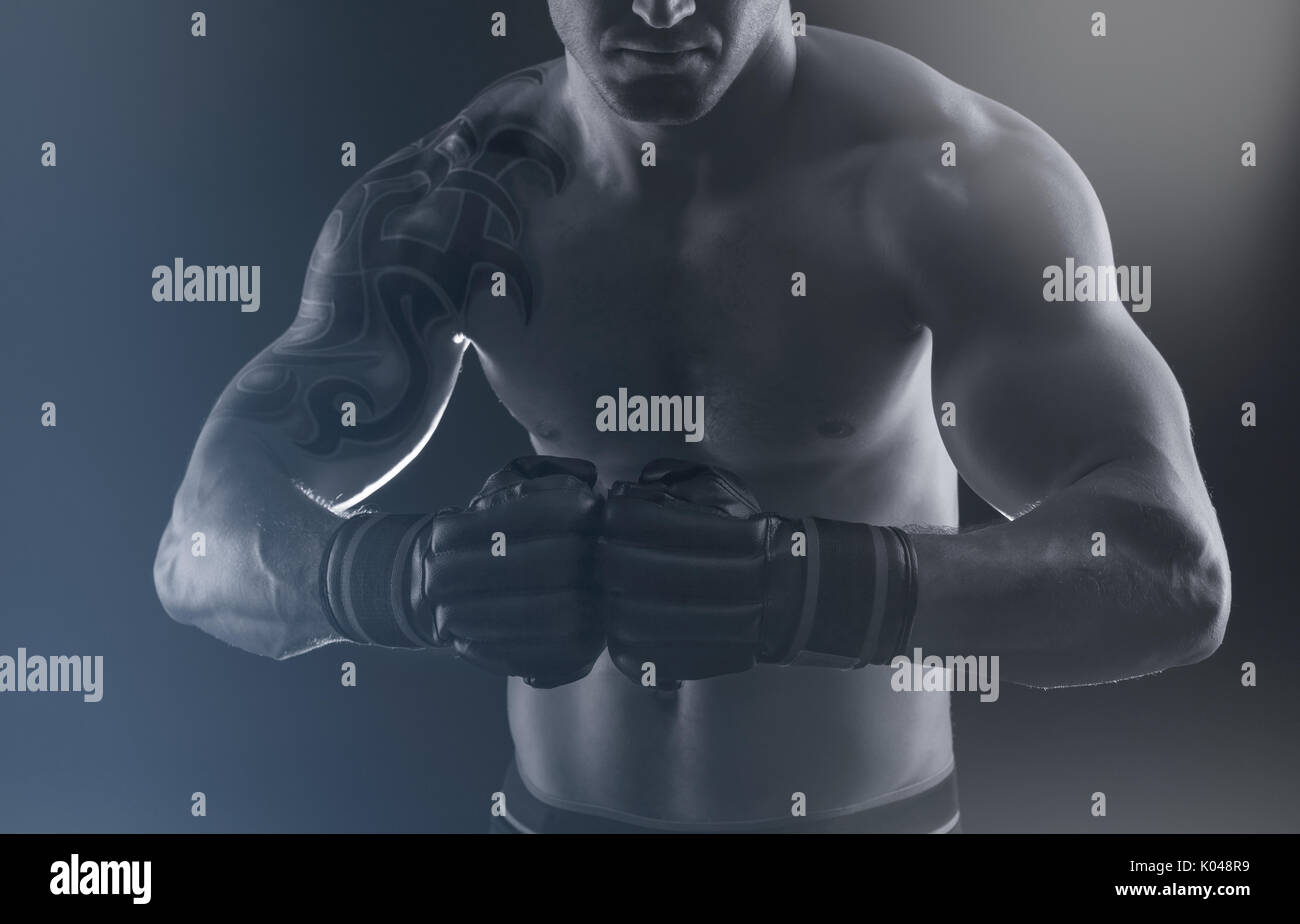 Boxer with boxing gloves before a fight on a black background. Boxing ...