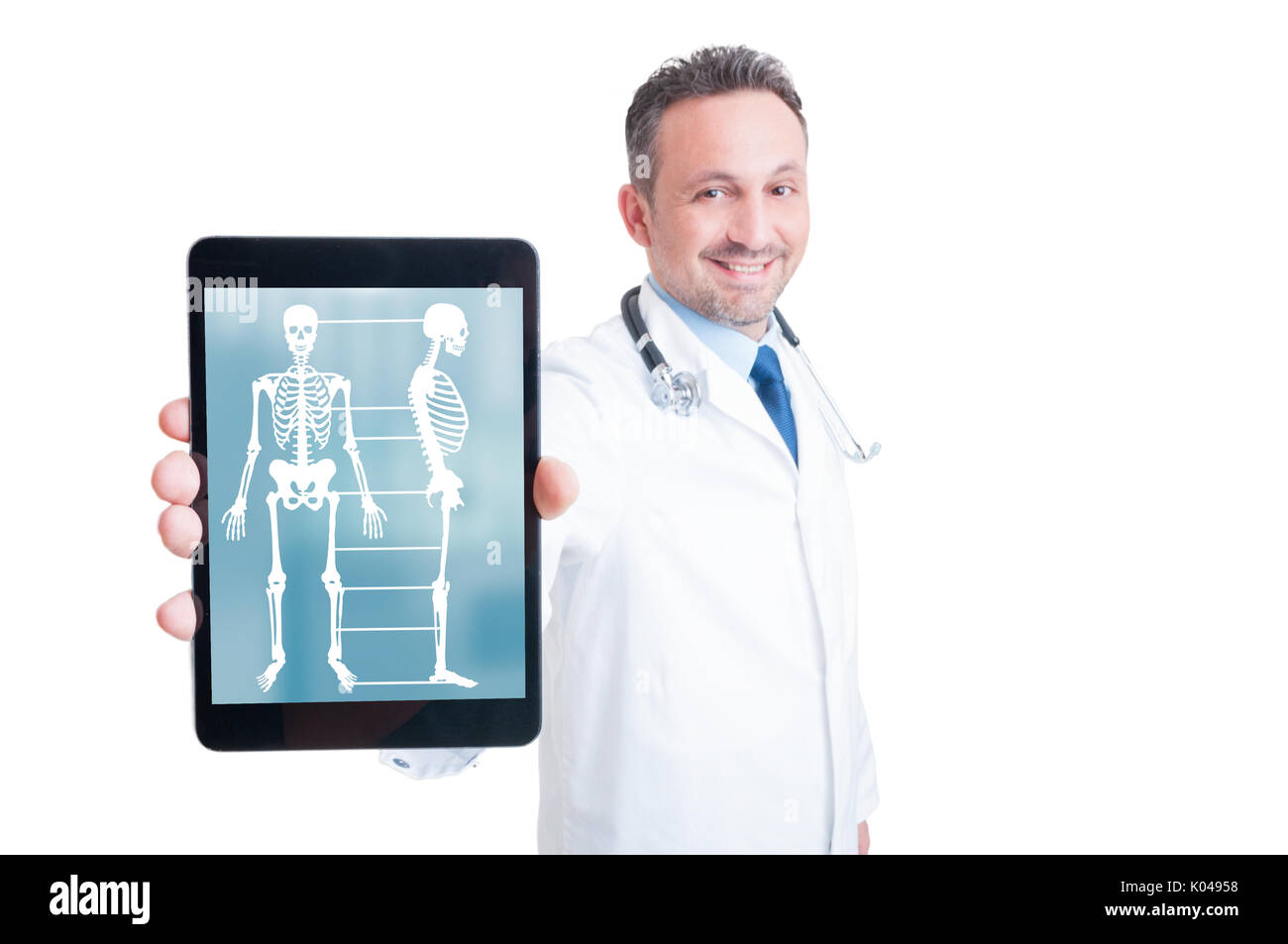 Smiling medic showing tablet pc computer screen with human skeleton ...