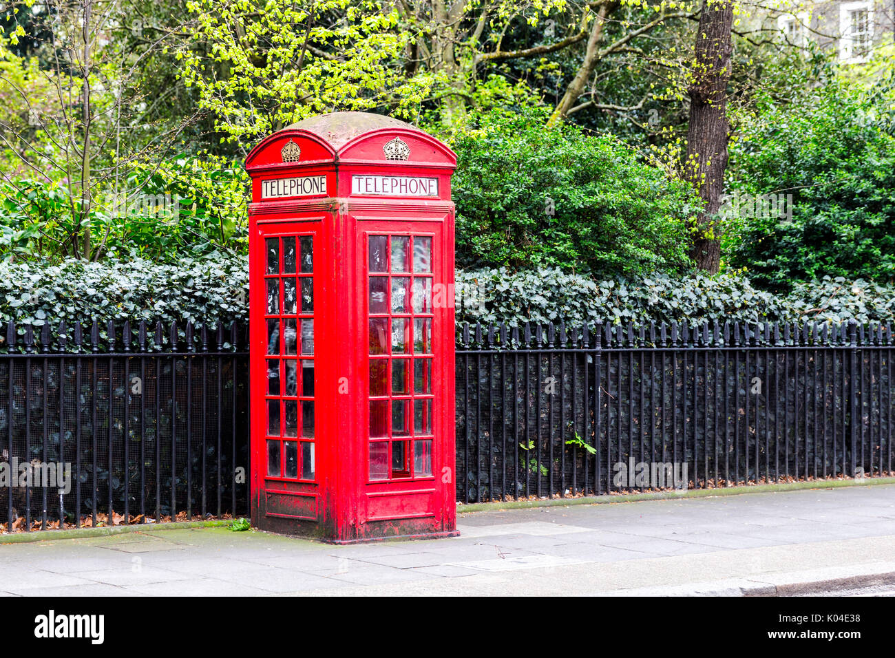 Red telephone box in street with historical architecture in London ...