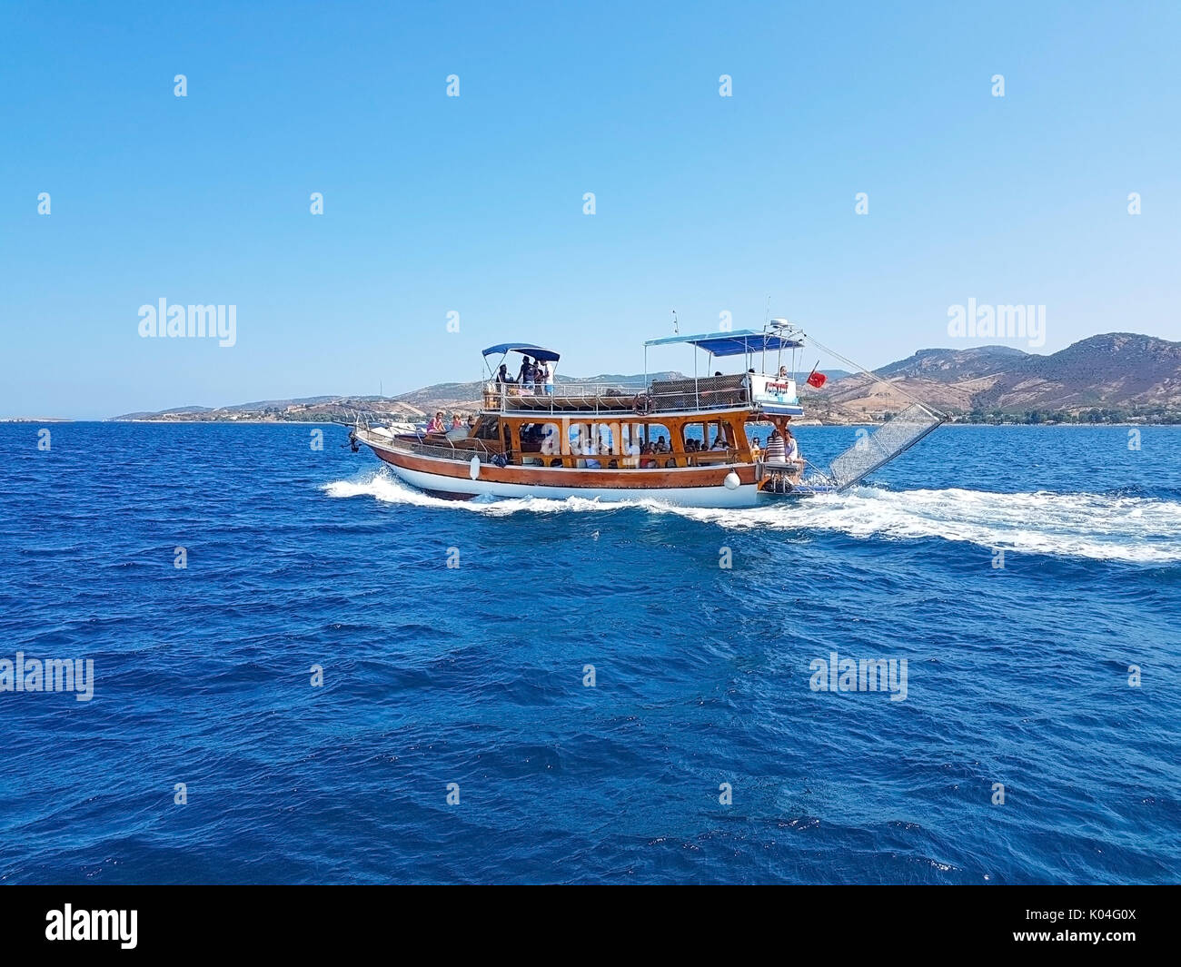 tour boat with passengers sailing in deep blue sea Stock Photo - Alamy