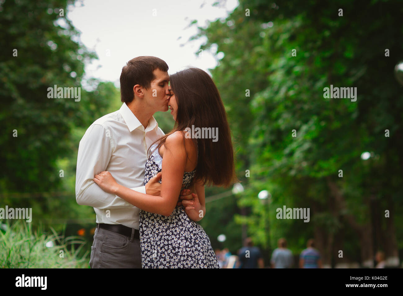 Beautiful young couple on a nature background Stock Photo - Alamy
