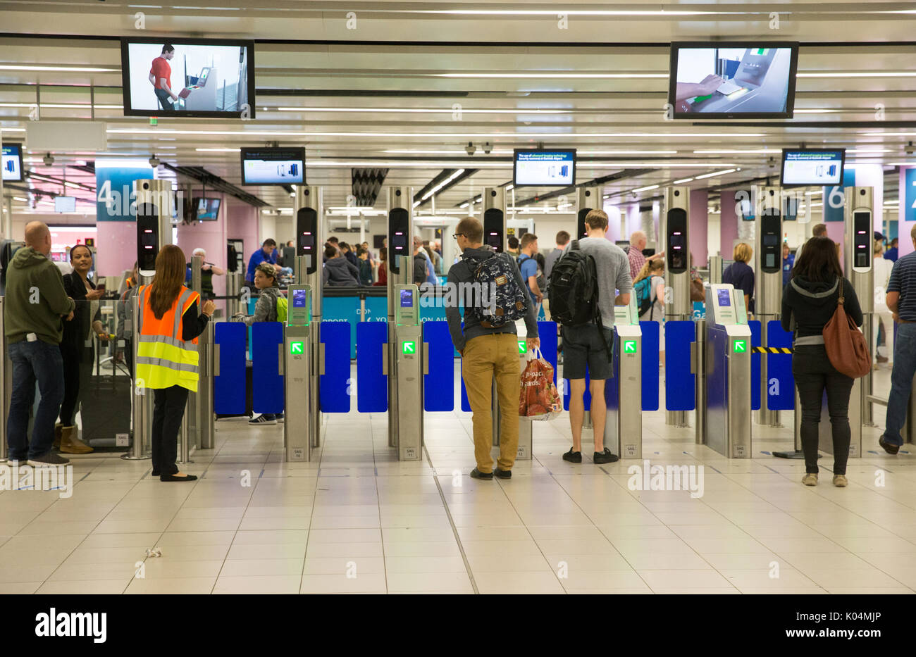 People At The Uk Border At Gatwick Airport Waiting To Go Through The Epassport Gates To Check