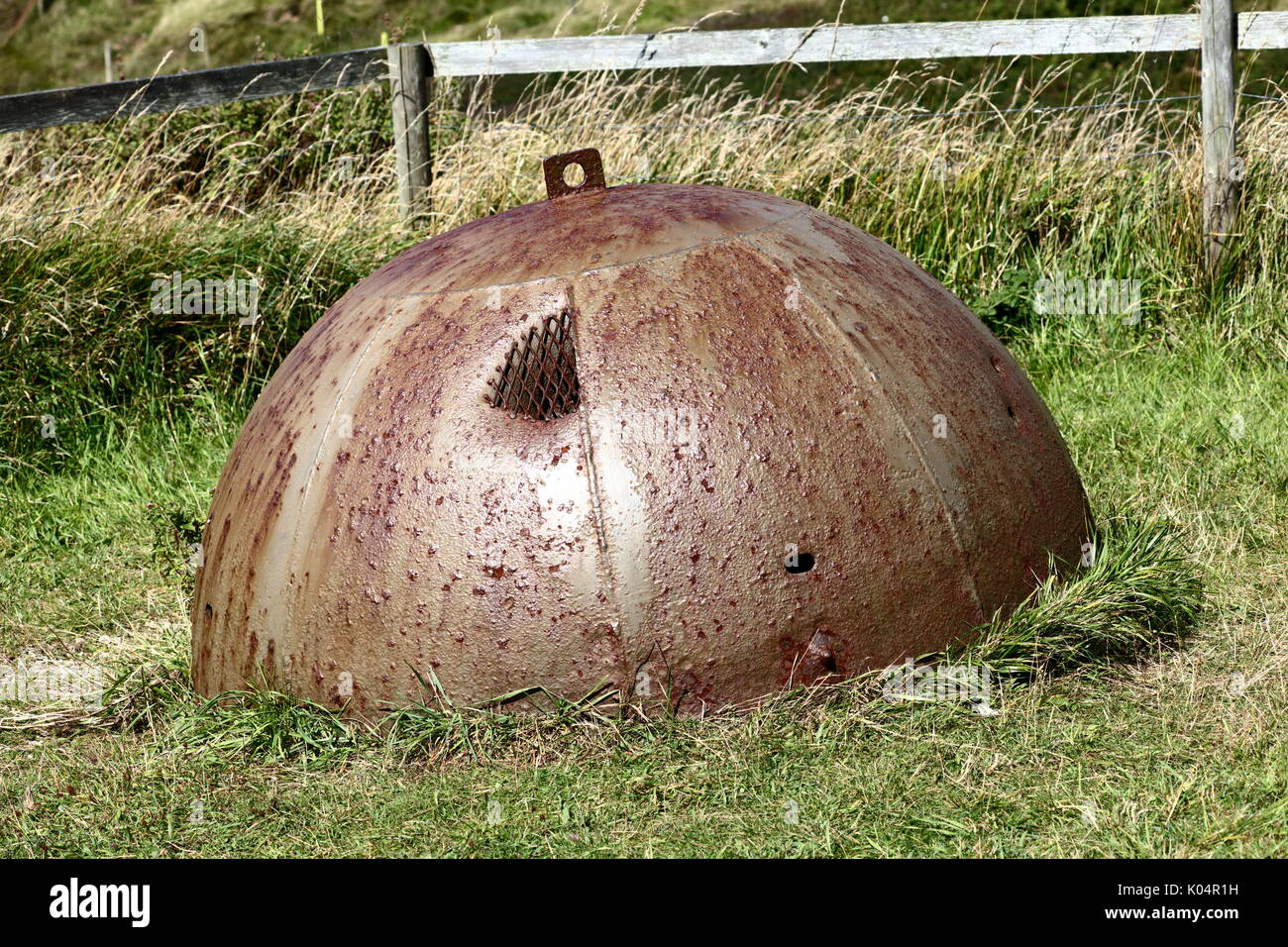 Colourful rusted remains of large steel marine marker / mooring buoy ...