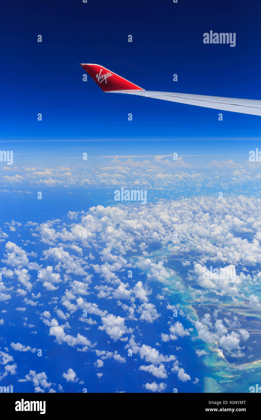 Wing and red logo of a Virgin Atlantic Airline plane in the sky above ...