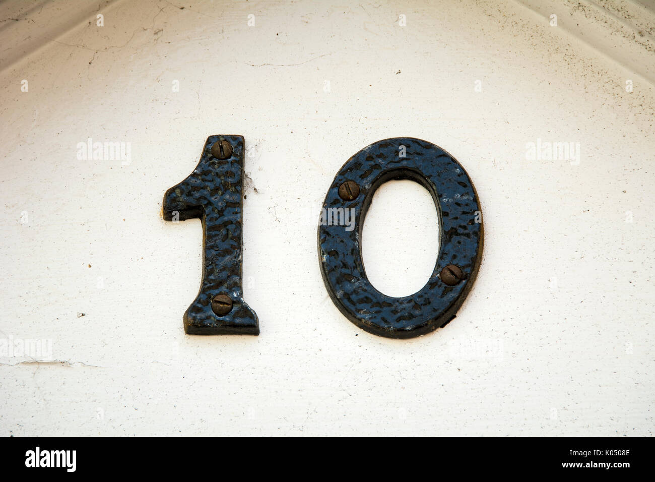 Door number ten sign on plaster wall Stock Photo - Alamy
