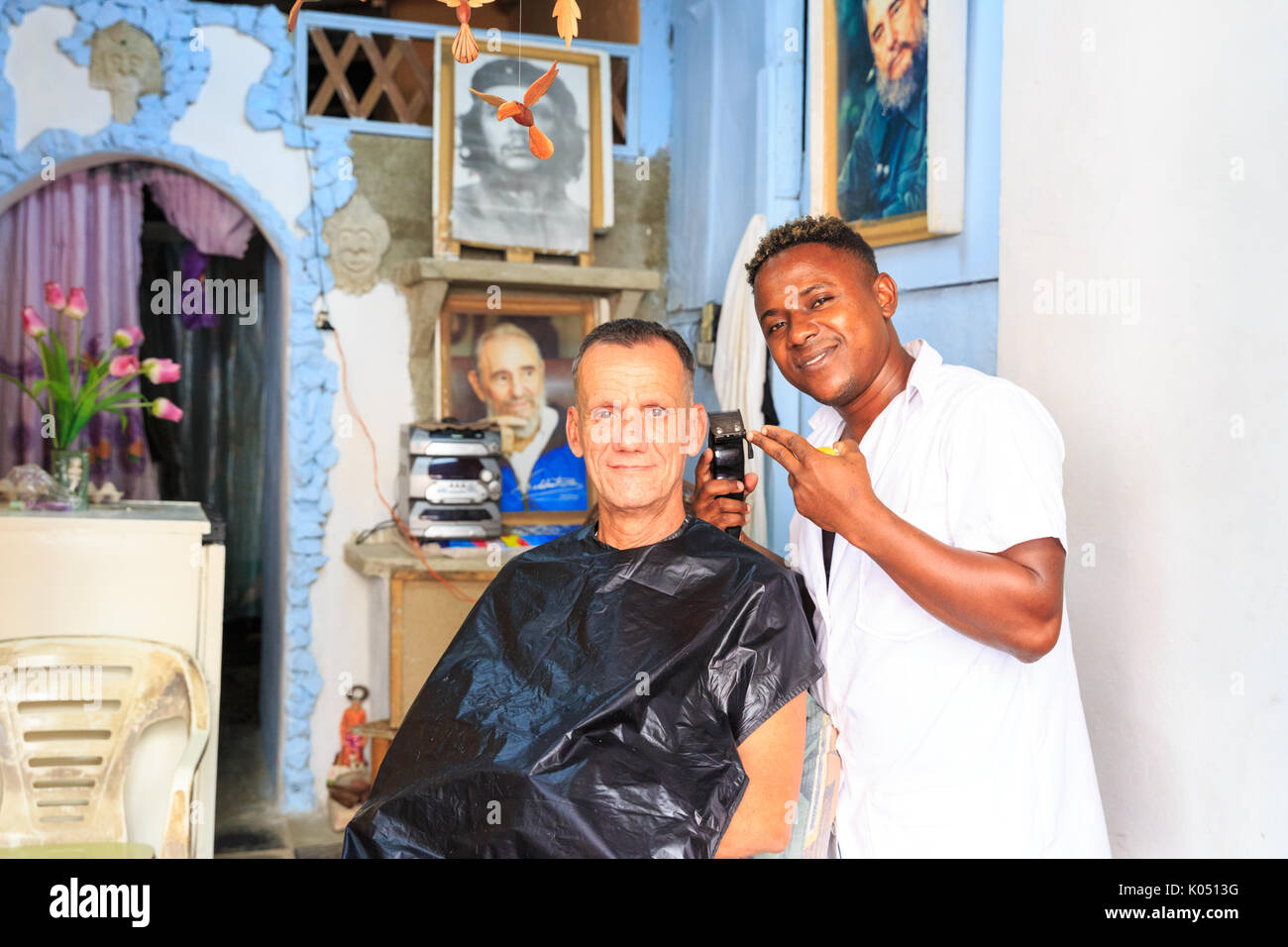 Barber and client in old fashioned barbershop and hairdressing salon ...