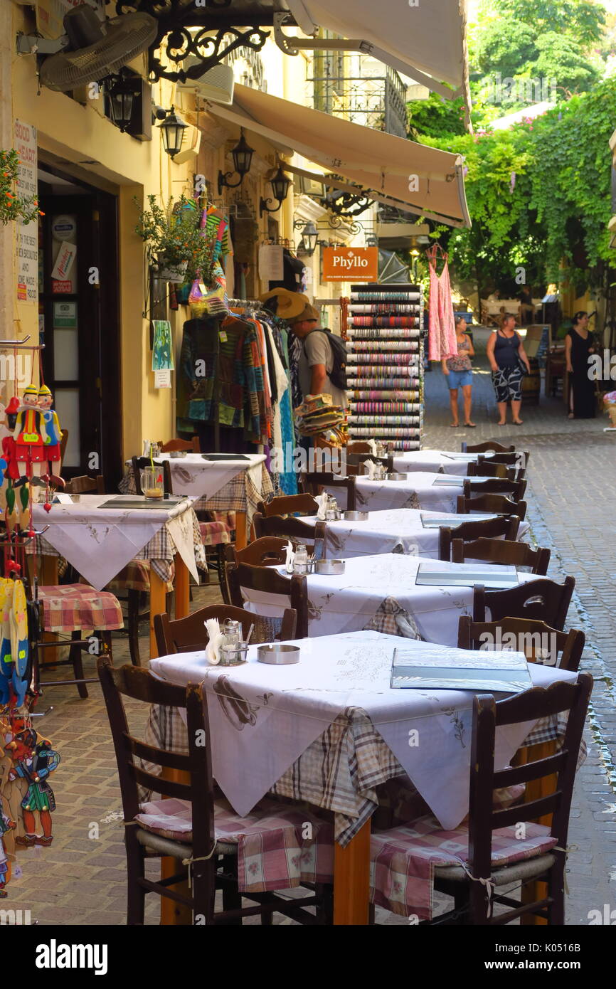 Tables and chairs outside a cafe in Chania on Crete Stock Photo - Alamy