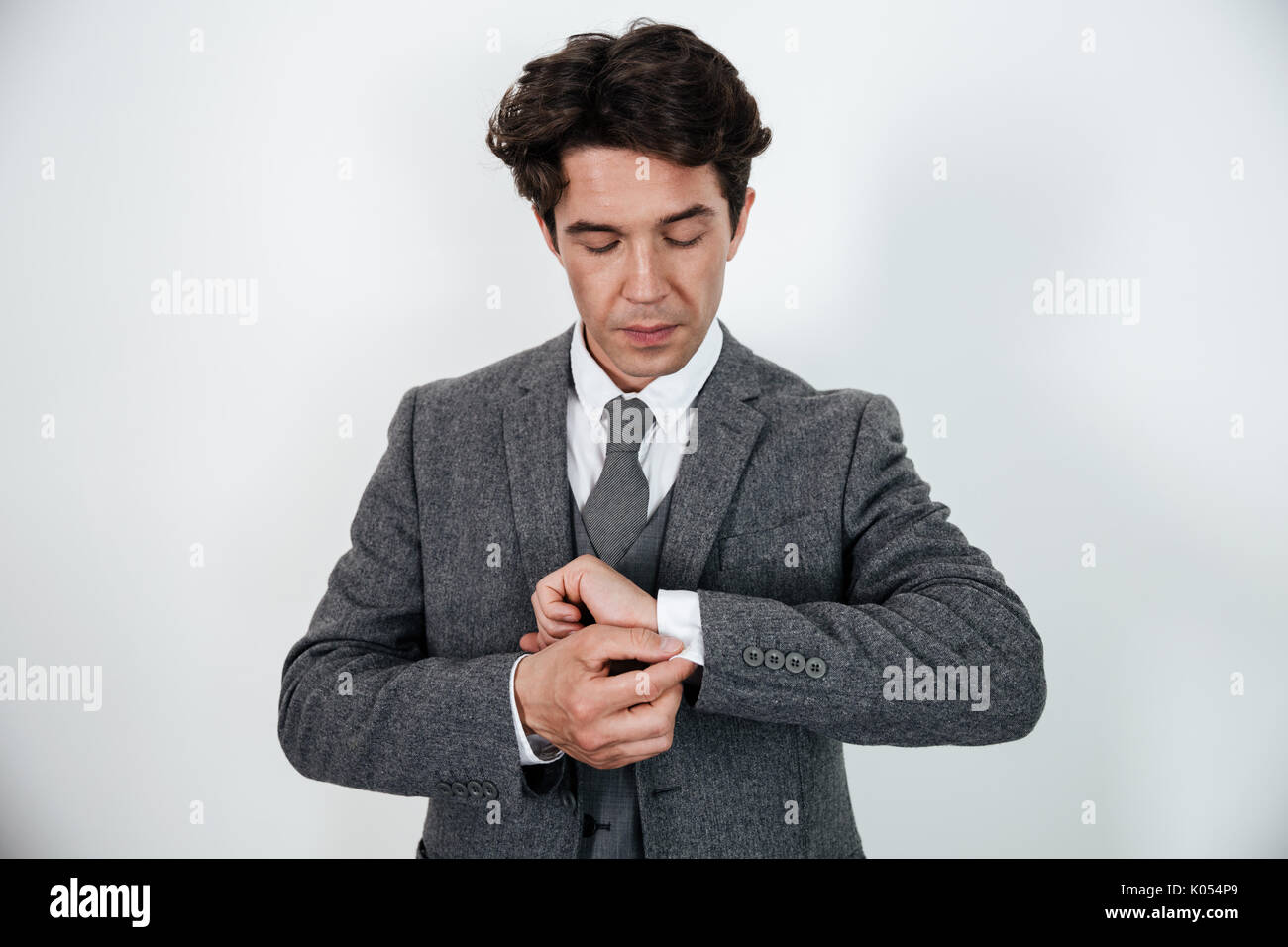 Suit buttoning businessman attractive hi-res stock photography and ...