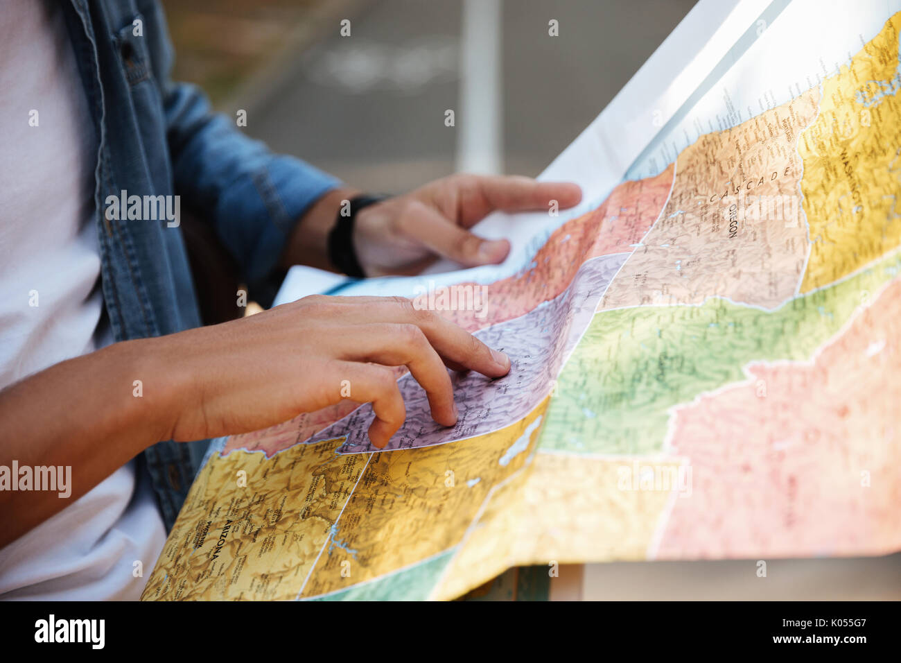 Young man looking at map hi-res stock photography and images - Alamy