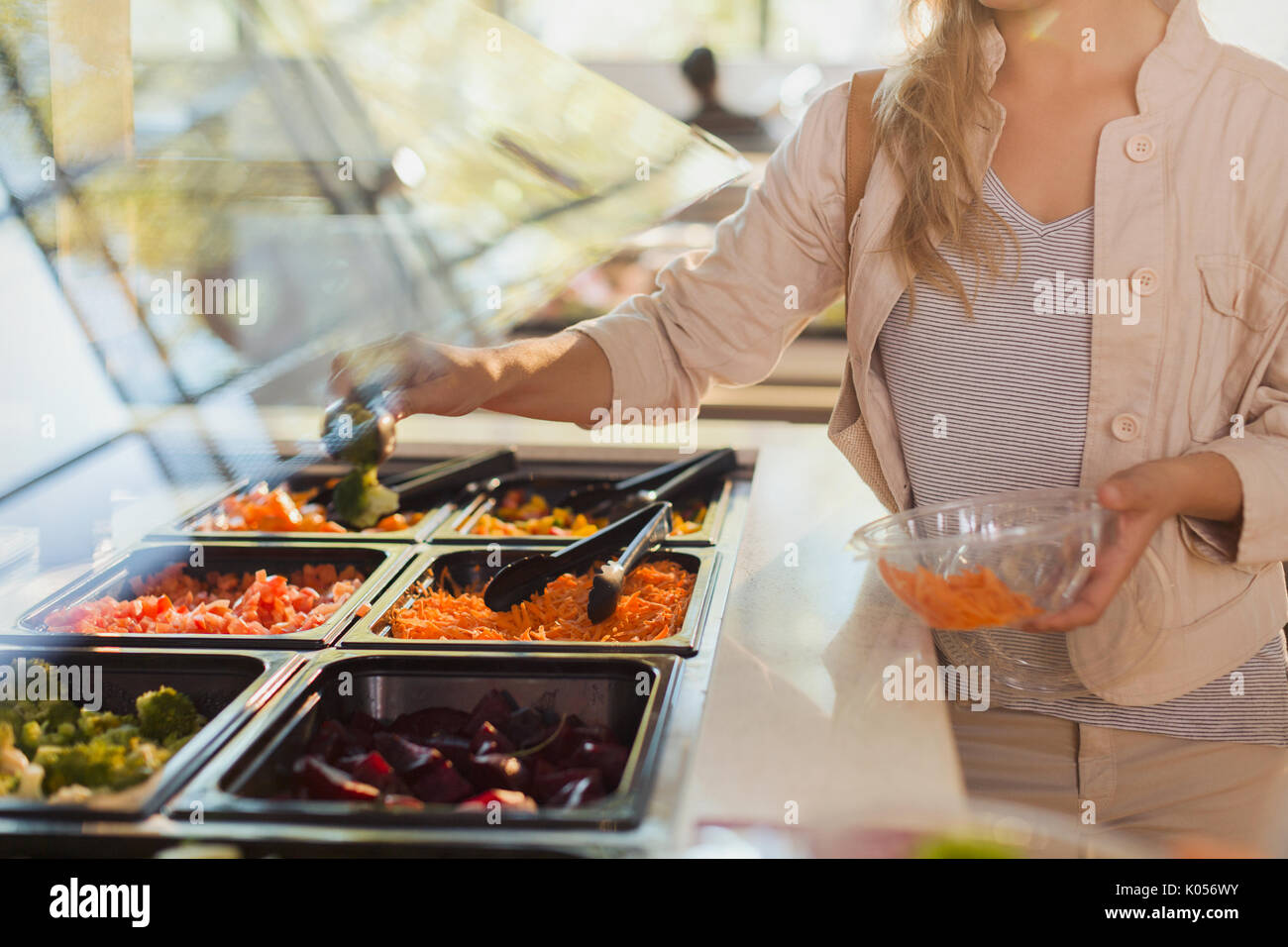 Young woman at salad bar in grocery store market Stock Photo - Alamy
