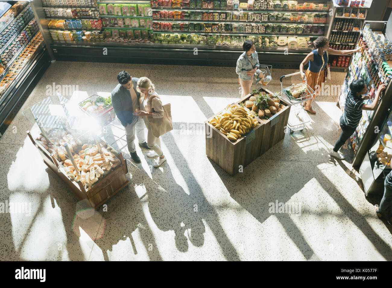 People grocery shopping in market Stock Photo - Alamy