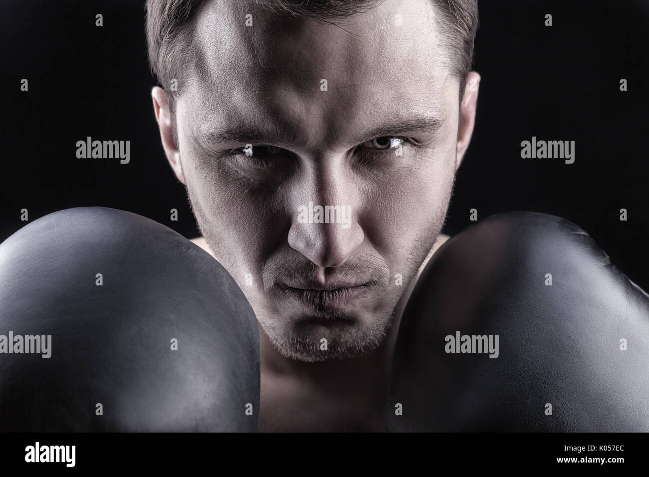 Boxer with boxing gloves before a fight on a black background. Boxing ...
