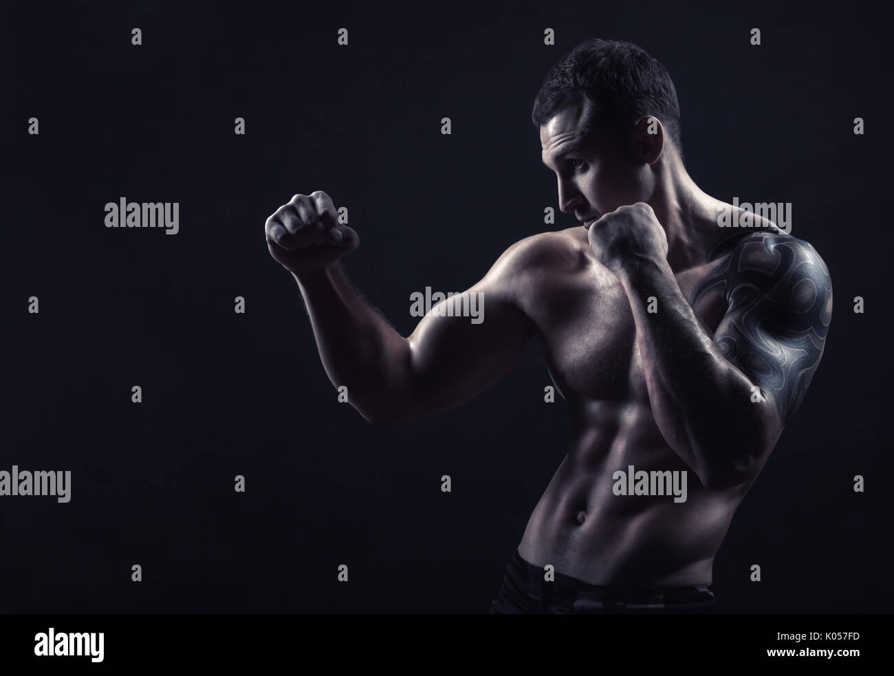 Man boxing. Young boxer fighter over black background Stock Photo - Alamy