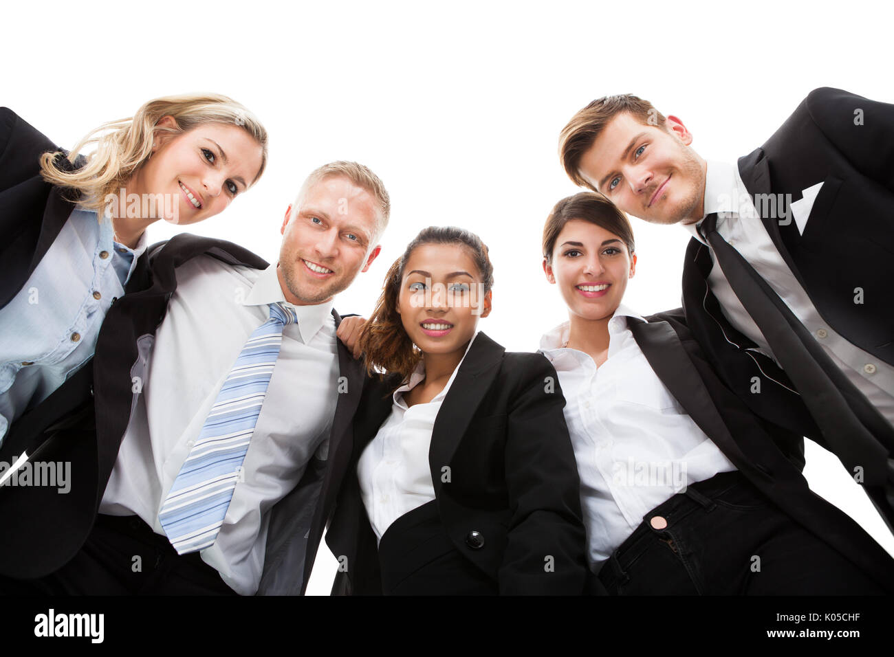 Low angle portrait of business people standing against white background ...