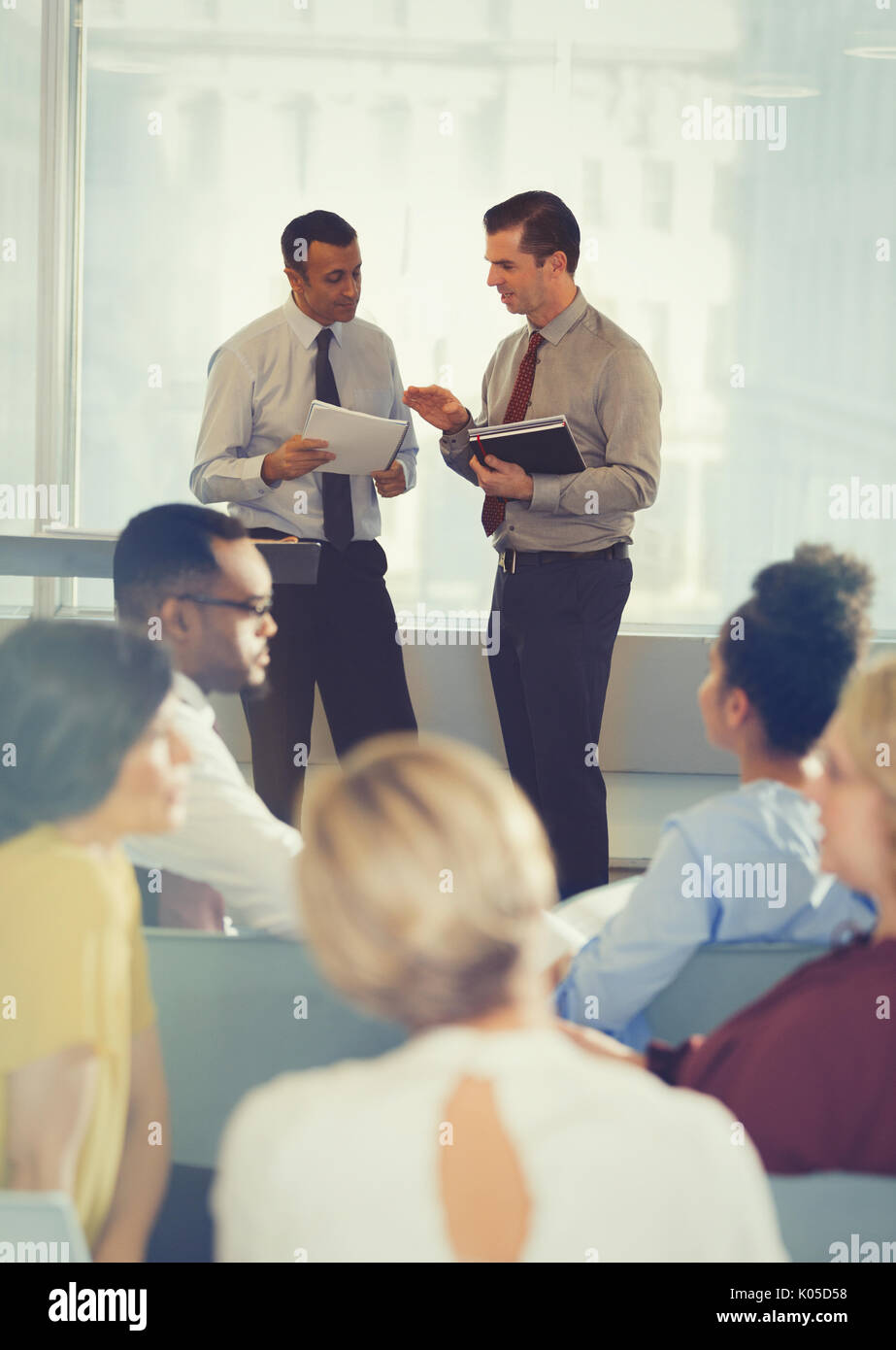 Businessmen talking in conference audience Stock Photo - Alamy