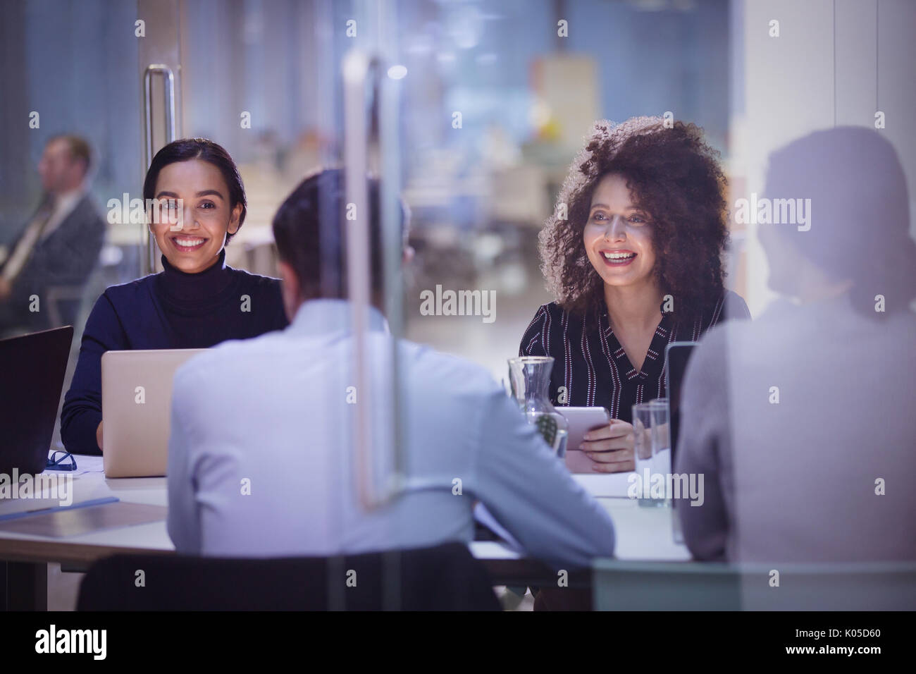 Businesswomen smiling in conference room meeting Stock Photo - Alamy