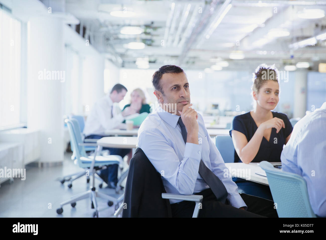Serious, attentive businessman listening in conference room meeting ...