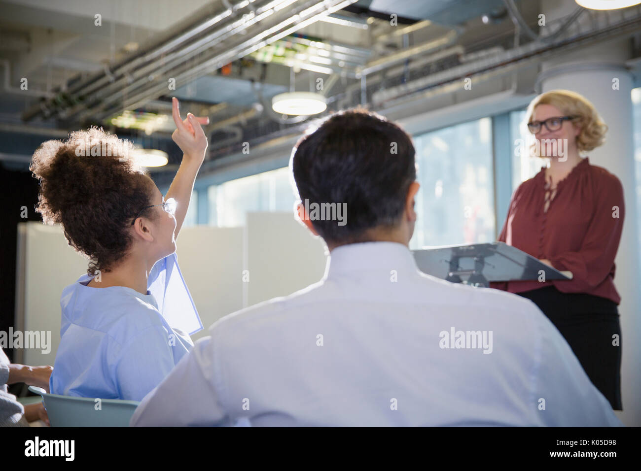 Businesswoman asking question in conference audience Stock Photo - Alamy