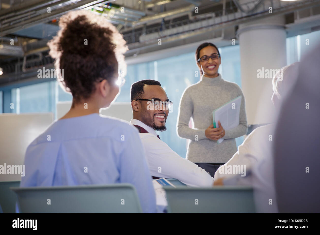 Smiling business people talking in conference audience Stock Photo - Alamy