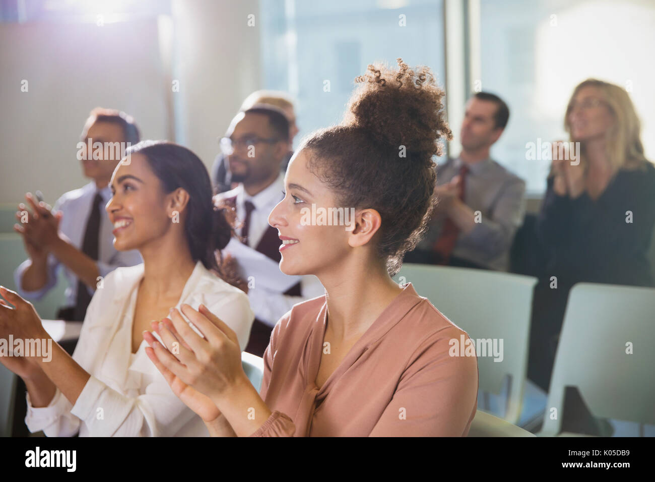 Businesswomen clapping in conference audience Stock Photo - Alamy