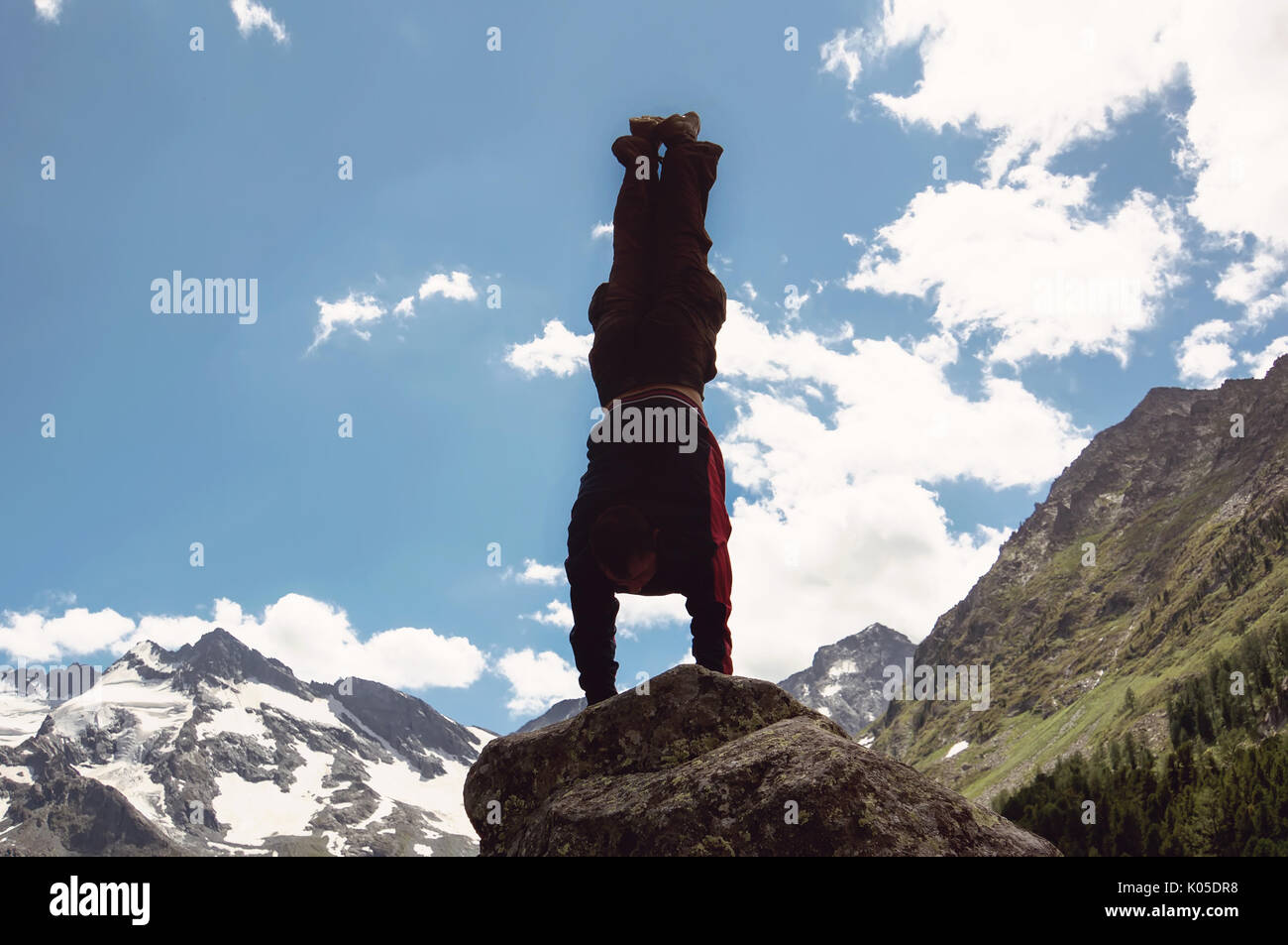 man doing complex Yoga exercise headstand. Amazing Yoga landscape in ...