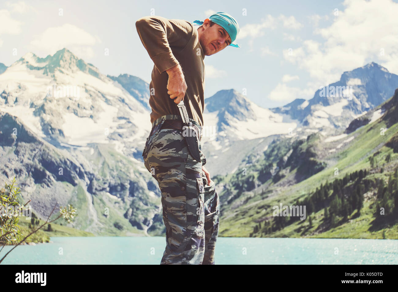 Man the hunter inserts the knife in the sheath on the background of ...