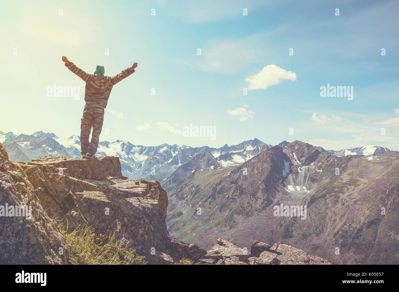 Crazy hiker standing on top of a mountain. Tourist enjoying life on ...