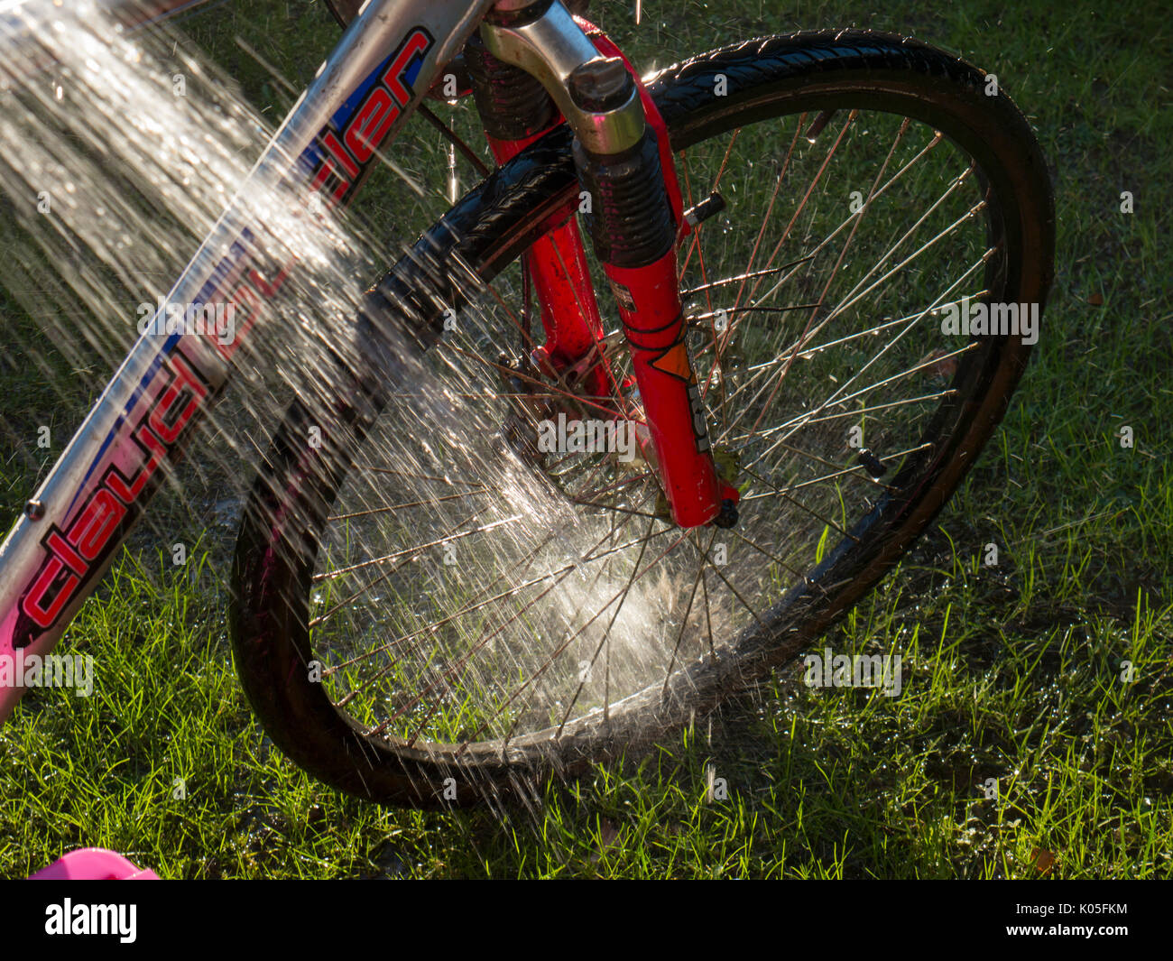 Cycle washing with hose Stock Photo - Alamy
