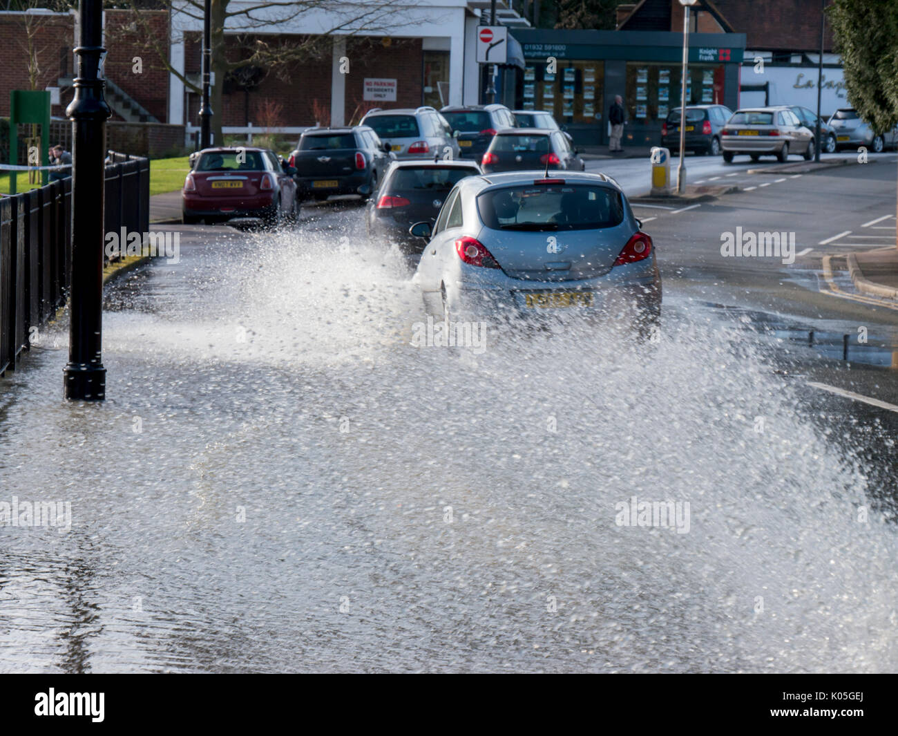 UK, Surrey, Cobham, flood water on road splash Stock Photo - Alamy
